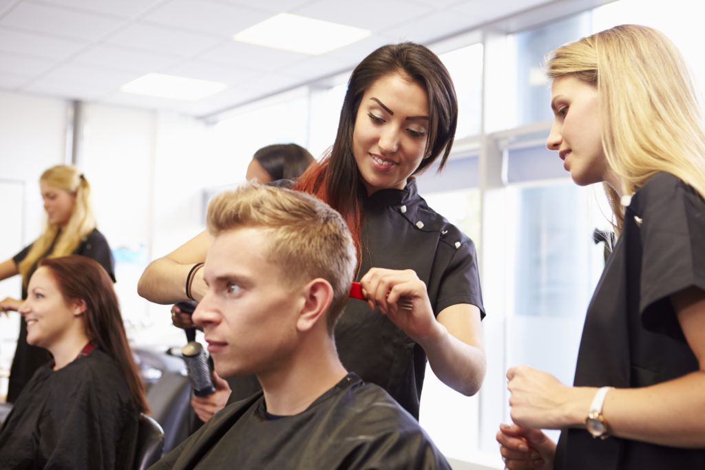 Teacher Helping Students Training To Become Hairdressers - Meridian College